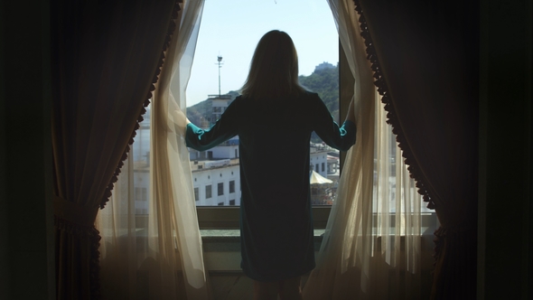 Young Woman Walking To Window and Opening Curtains Back View, Stock Footage