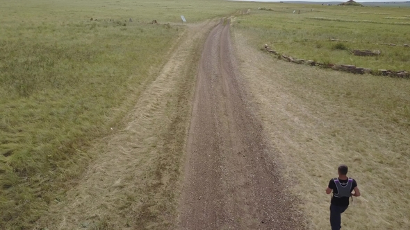 Male Athlete Running Through the Fields. Trail Running Athlete Moving ...