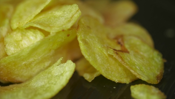 Potato Chips Rotating On Black Background. Potato Chips Are Rotated on ...