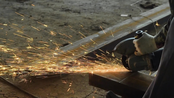 Shot of a Professional Builder Grinding on a Big Piece of Metal on a ...