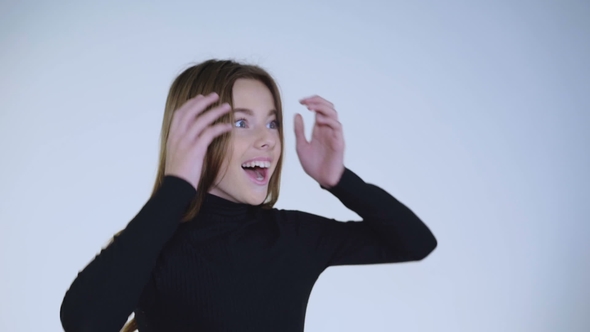 Portrait of Surprised Girl Corrects Her Hair and Nods Head at Camera ...