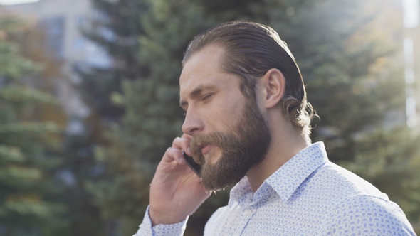 Handsome Man Makes a Call and Softly Talks on the Smartphone with Smile ...