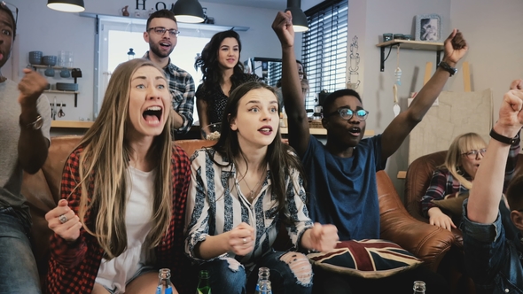 Multi Ethnic Supporters Watch Sports Game on TV. . Diverse Football ...