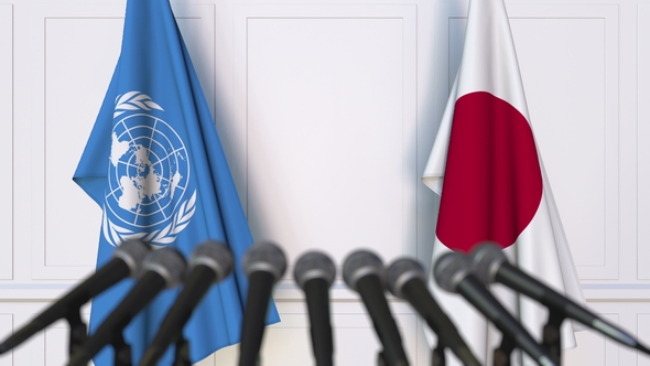 Flags of the United Nations and Japan at International Press Conference ...