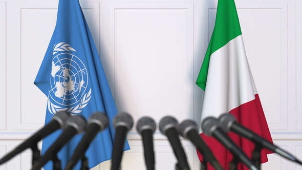 Flags of the United Nations and Italy at International Press Conference ...