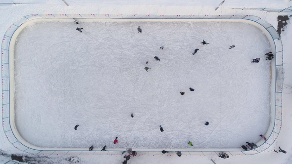 People Are Skating on Ice Rink in the Sunny Day. Aerial Vertical Top ...
