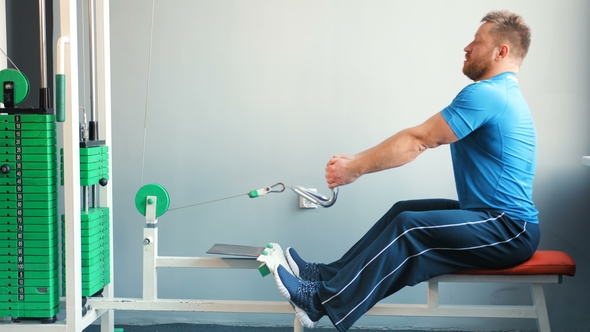 Athletic Man Working Out on Simulator in Training Gym, Stock Footage