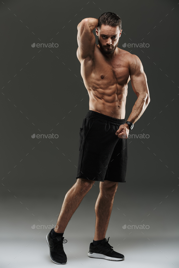 Full length portrait of a confident muscular bodybuilder Stock Photo by ...
