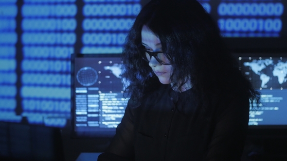 Bespectacled Woman Hacker Programmer Is Working on Computer in Cyber ...
