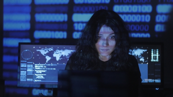 Woman Hacker Programmer with Curly Hair Is Working on Computer in Cyber ...