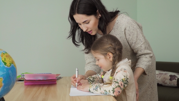 Mother Help Little Girl To Write Correctly in Notebook, Stock Footage