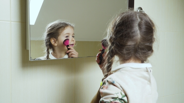 Cute Little Girl Applies Powder on Her Face with Brush in Front of ...