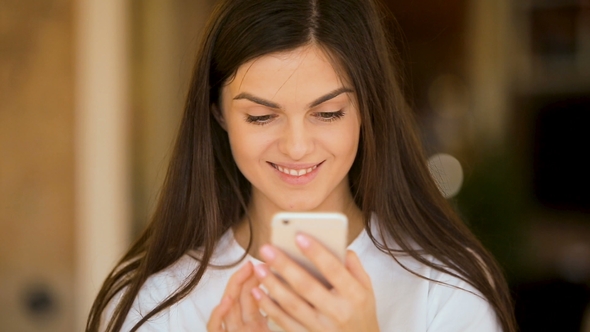 Intrigued Girl Smiles As Texting, Stock Footage | VideoHive