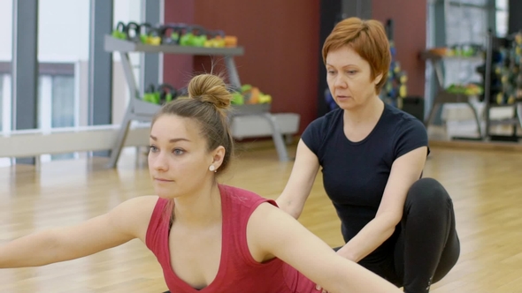 Yoga Teacher in Training Helps To Make a Woman Poses Asanas for Balance ...