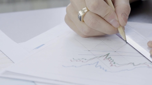 Young Professional Is Drawing on Documents Sitting in Modern Office ...