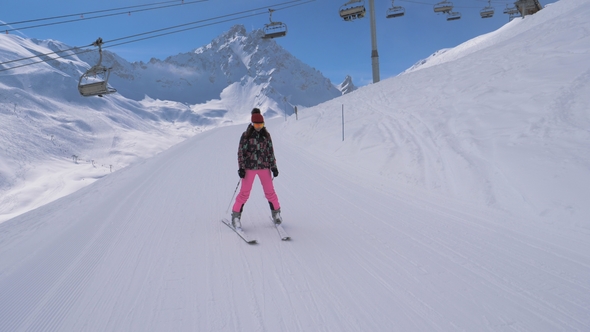 Sporty Woman Is Skiing Down the Slope Under the Lifters, Stock Footage