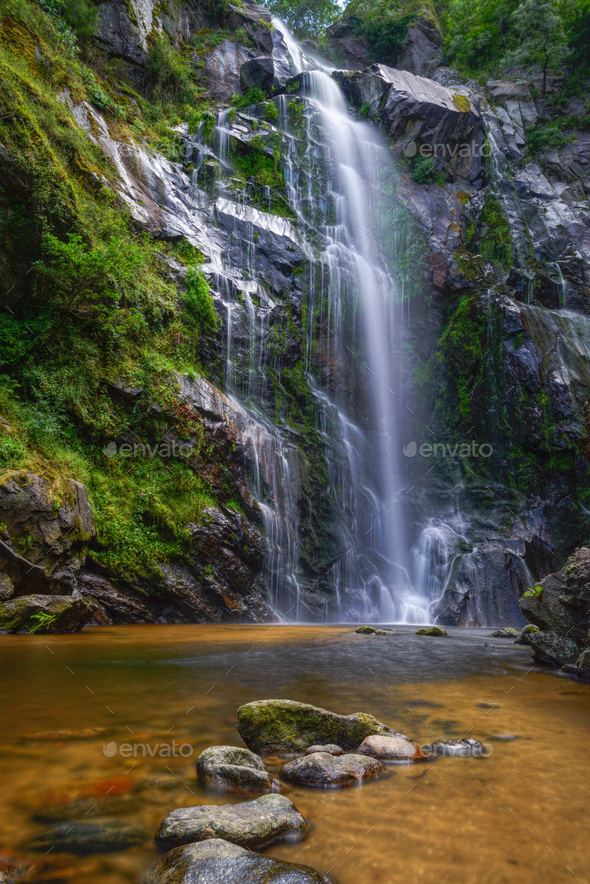 Spectacular waterfall on a rocky cliff Stock Photo by luisvilanova