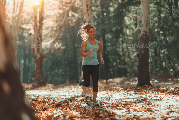 Woman Jogging Outdoors in The Fall Stock Photo by microgen | PhotoDune