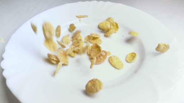 Corn Flakes Fall on White Dish, Stock Footage | VideoHive
