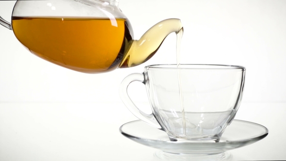 Tea Pouring. Tea Being Poured Into Glass Transparent Tea Cup. Tea Time ...
