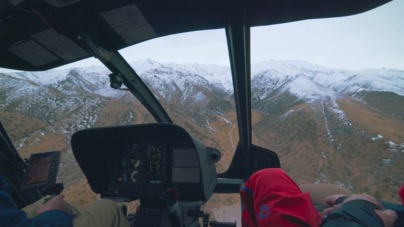 Inside View of a Helicopter in Flight, with Man and Pilots Flying Over ...