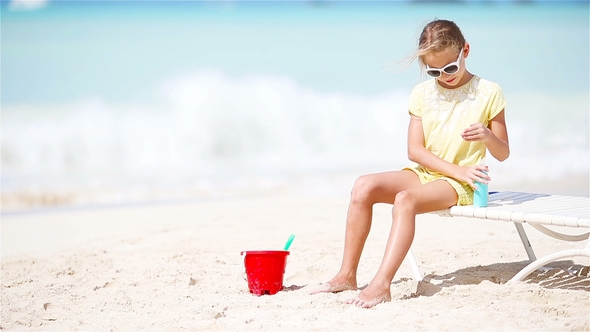 Little Adorable Girl with Sunscreen Is Protected From the Sun, Stock ...