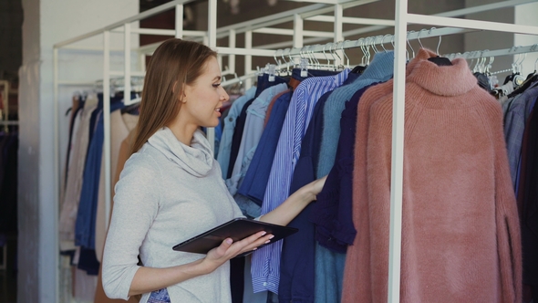 Women's Clothing Shop Owner Checking and Counting Garments on Rails ...