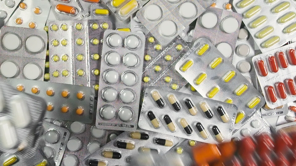 Pills and tablet closeup. Medicinal drugs fall. Medication capsule ...