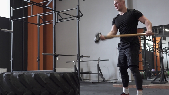 Male Athlete Doing Sledgehammer Swing Exercise in Cross Fit Gym, Stock ...