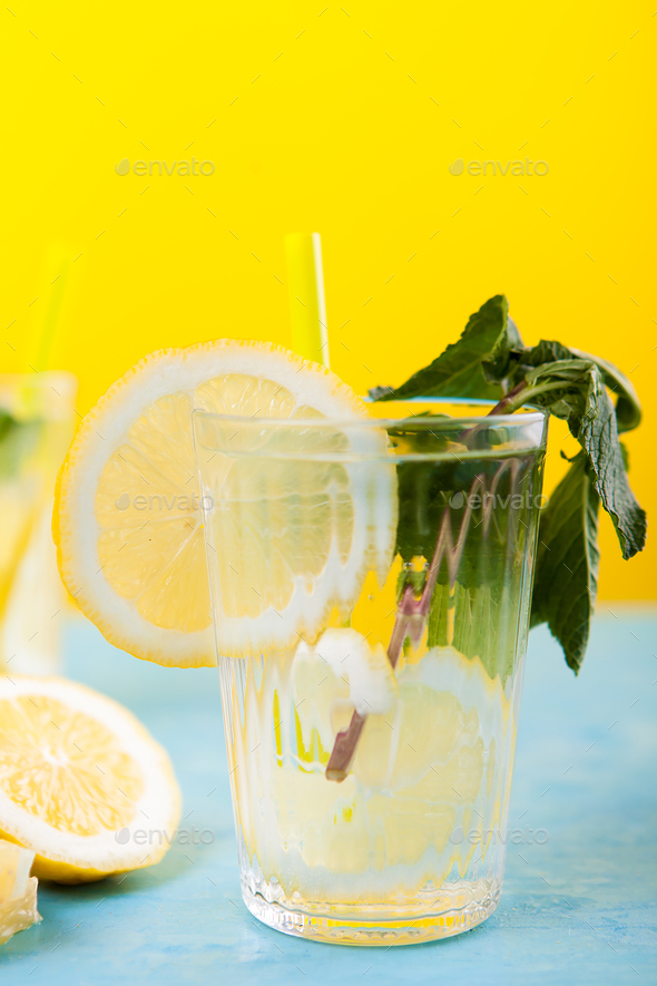 Cold lemon water drink for hot summer days Stock Photo by DC_Studio