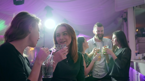 Attractive Girls Have Fun with Cocktails in Hands Behind the Bar ...
