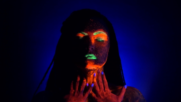 Girl Sexy Smears and Rubs Fluorescent Paint on Her Body. Dye Glowing ...