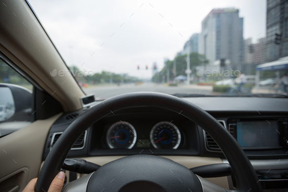 Driving car waiting the traffic light on street Stock Photo by lzf