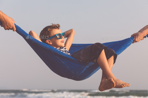 Happy little boy relaxing on the beach at the day time Stock Photo by ...