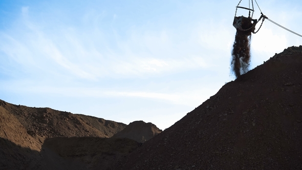 Dragline Excavator Loads Ore. The Ore Is Poured Out of the Bucket ...