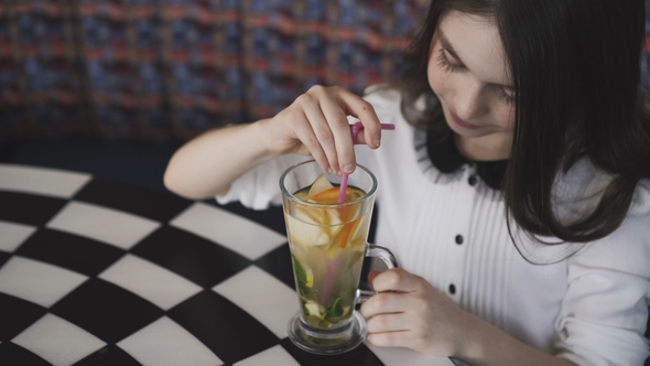 Beautiful Girl Stirring Lemonade with Tubule and Smiling at Camera in ...
