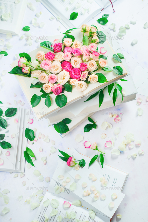 Stack of white books with flowers and petals. Spring reading concept ...