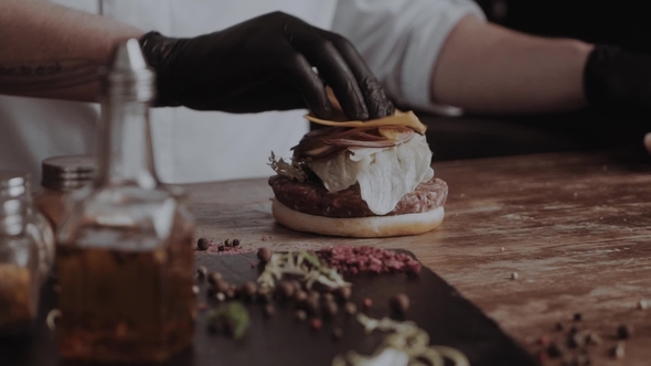 Chief Cook Preparing Fresh Burger in the kitchen.Burger Restaurant Menu ...