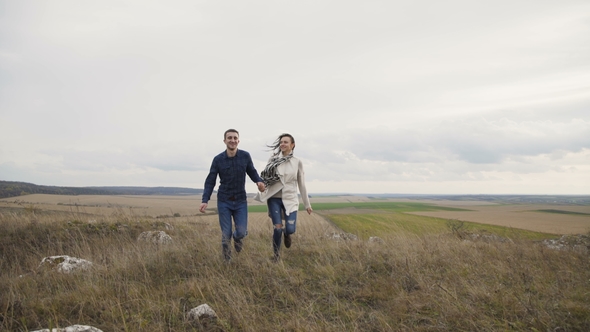 Romantic Young Couple Running and Spinning Around on a Rock., Stock Footage