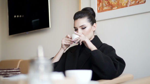 Beautiful Girl Drinking Tea or Coffee in Cafe. Beauty Model Woman ...