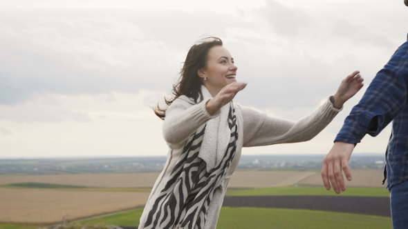 Romantic Young Couple Hug and Spin Around on a Rock., Stock Footage