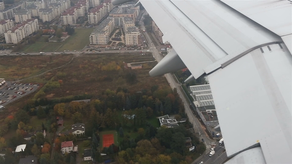 View Through an Airplane Window Flying Over the City Through Clouds ...