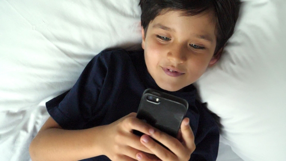 Boy Playing on Phone, Stock Footage | VideoHive