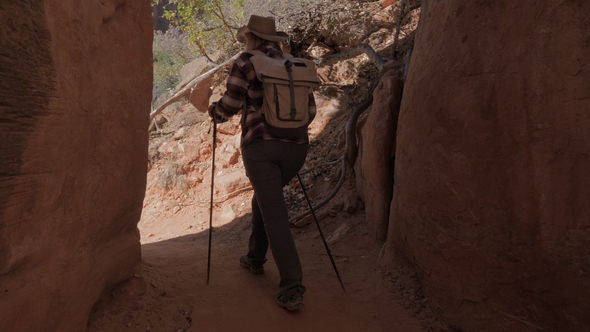 Woman Hiker Walking Out Of The Cave Between The Rocks Of The Canyon On ...