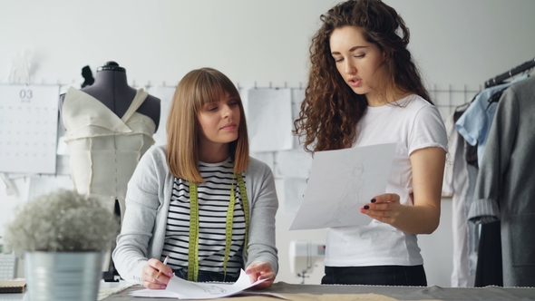Professional Female Fashion Designers Are Looking at Sketch and ...