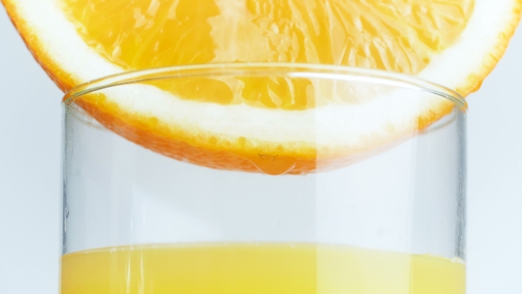 Footage of Juice Droplets Falling in Glass From Orange Slice, Stock Footage