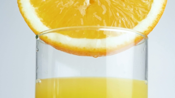 Footage of Juice Droplet Slowly Dripping From Orange Half, Stock Footage