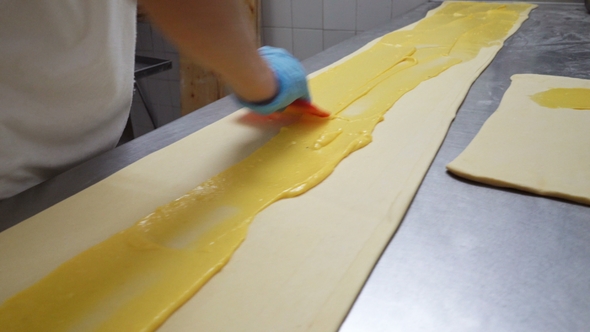 Traditional Italian Bakery. Woman Baker Smears the Dough with Cream ...