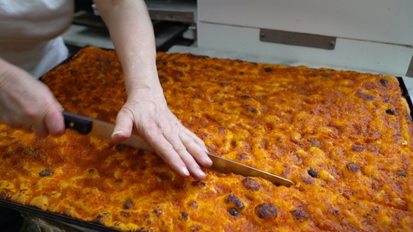 A Female Baker Cuts a Big Pie into Pieces, Stock Footage | VideoHive
