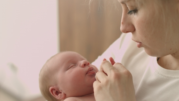 Nurse Is Rocking Newborn Baby on the Hands, Stock Footage | VideoHive